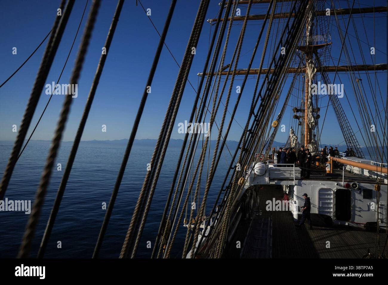 People tour the U.S. Coast Guard Barque Eagle tall ship while at anchor ...