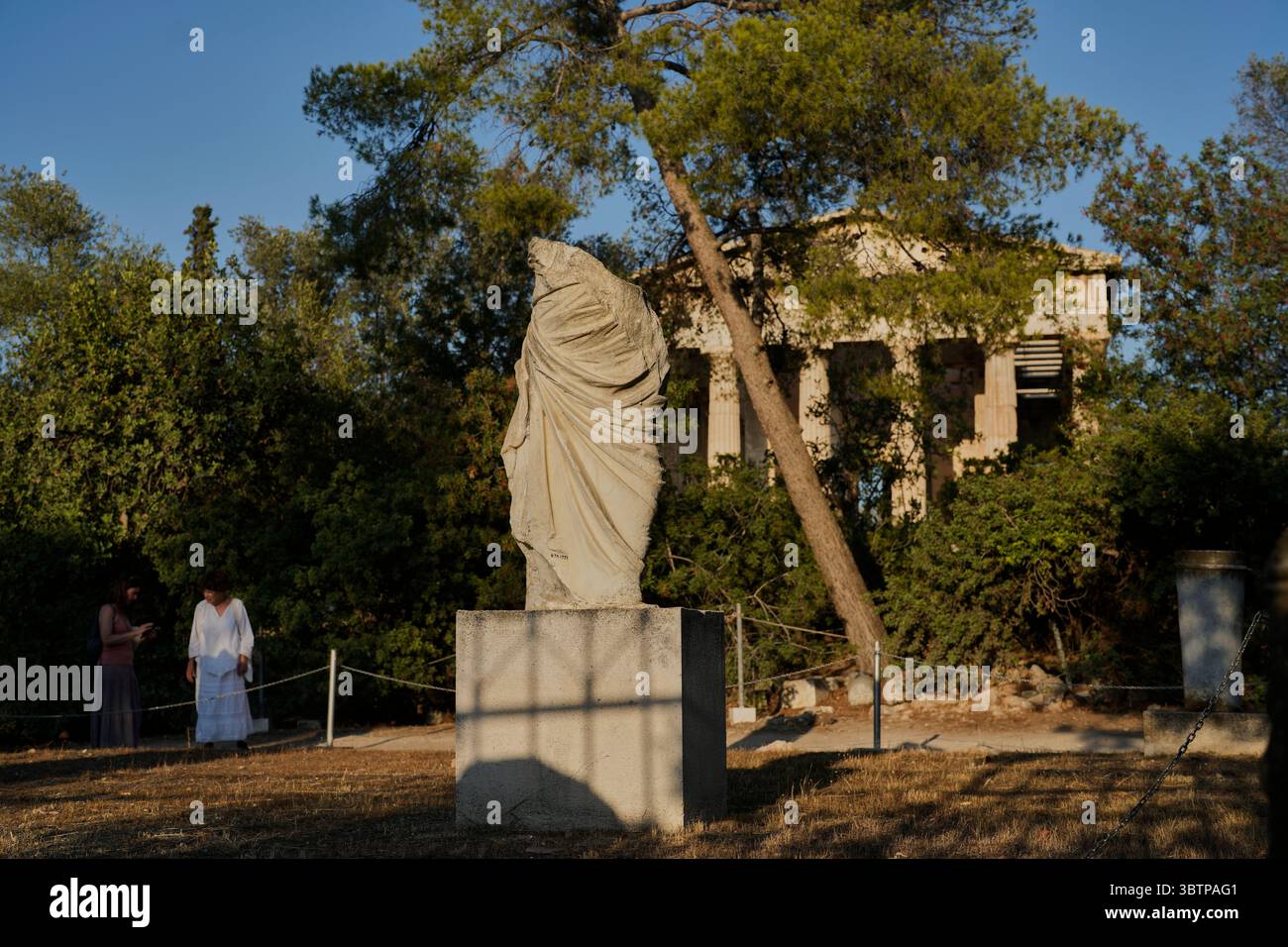 Tourists visit the ancient Agora as at the background stands 2,400-year-old Temple of Hephaestus ...