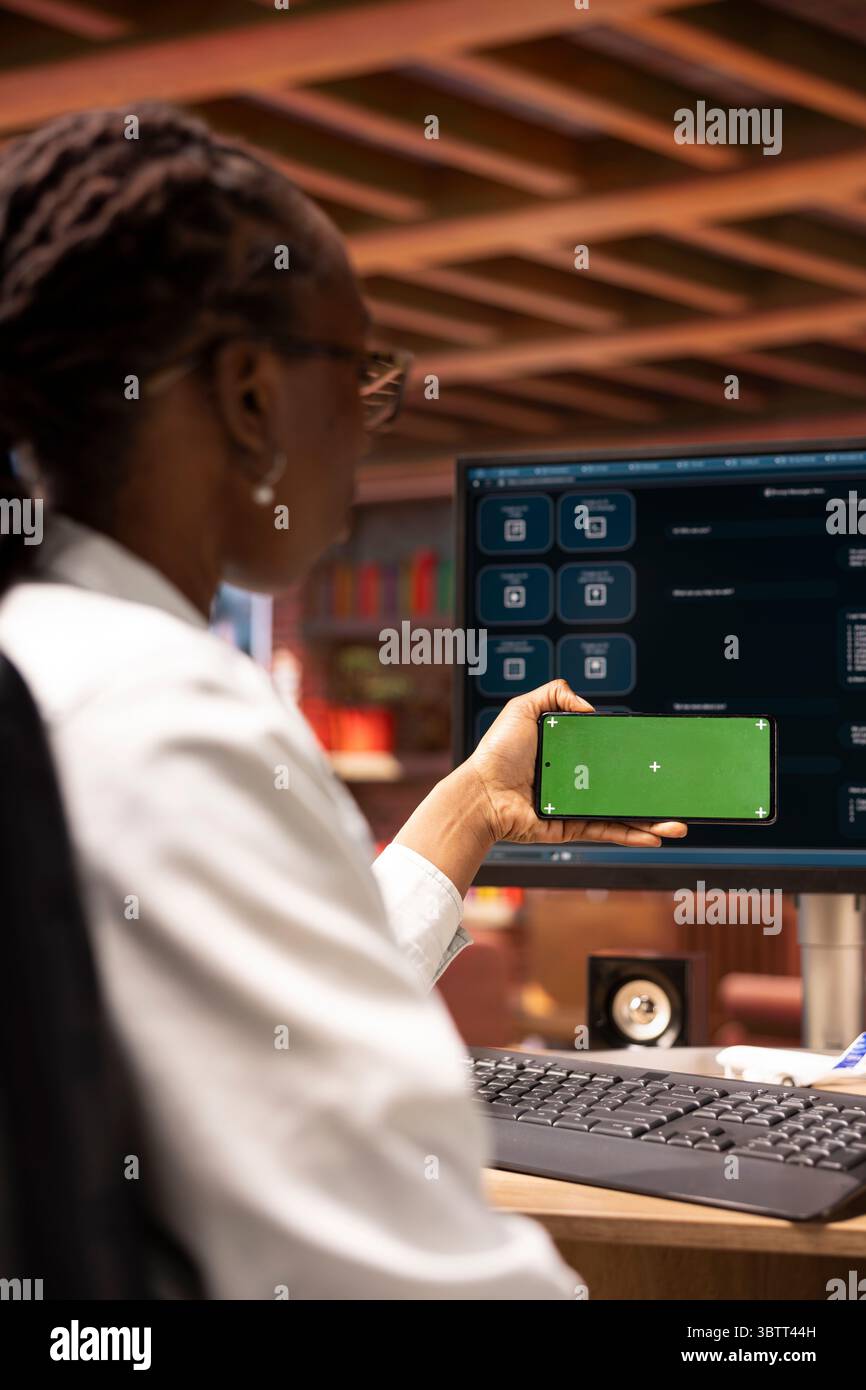 Woman using mockup smartphone and AI LLM chatbot on computer screen in ...