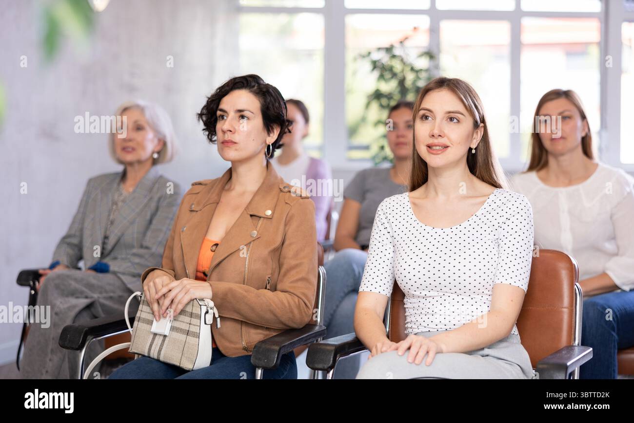 In audience, students sit staring at teacher and listen to lecture ...