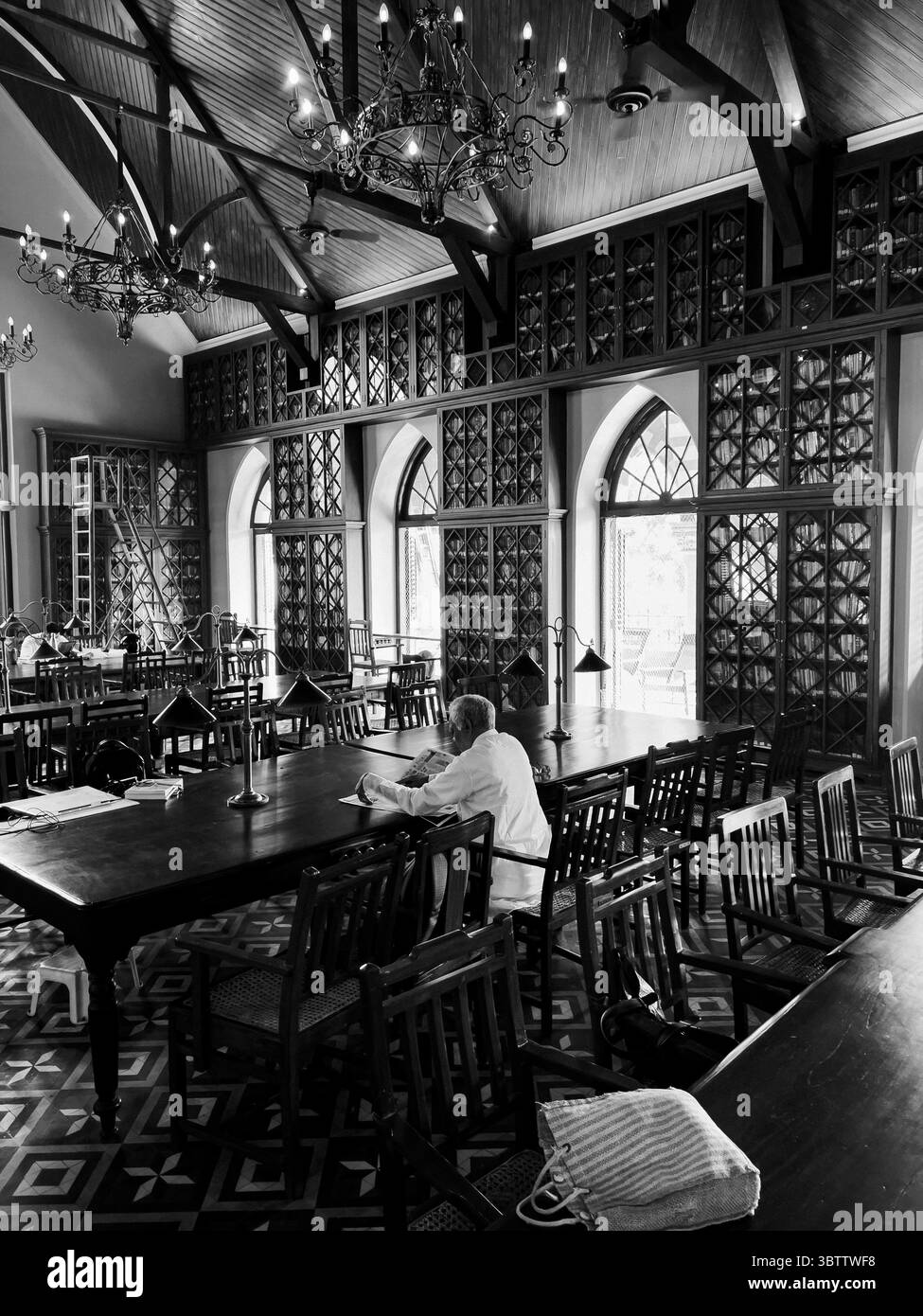 Interior of an old library in Mumbai, India, with people reading and ...