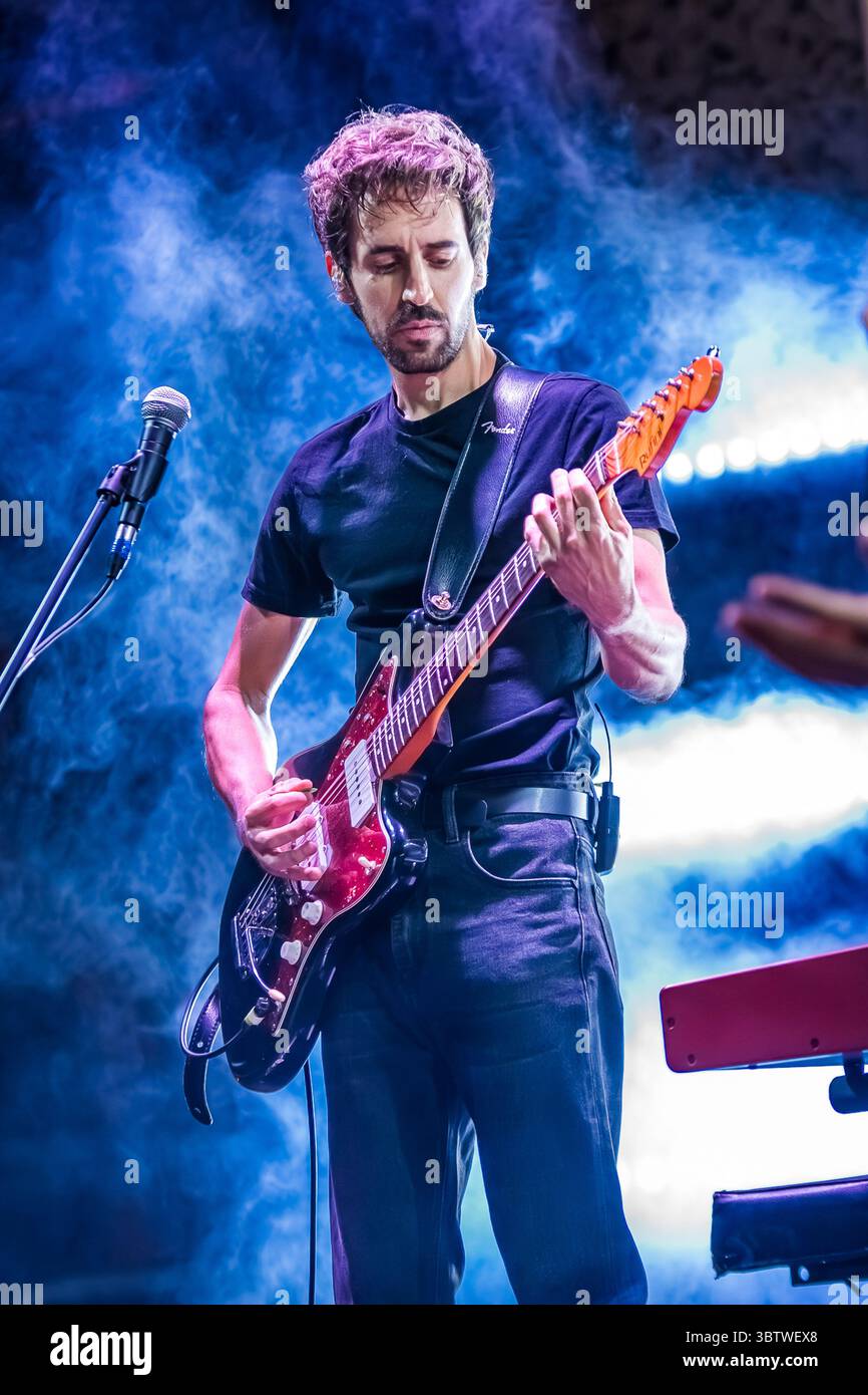 Daniele Ghiandoni play the guitar during the Music Concert Fast Animals ...