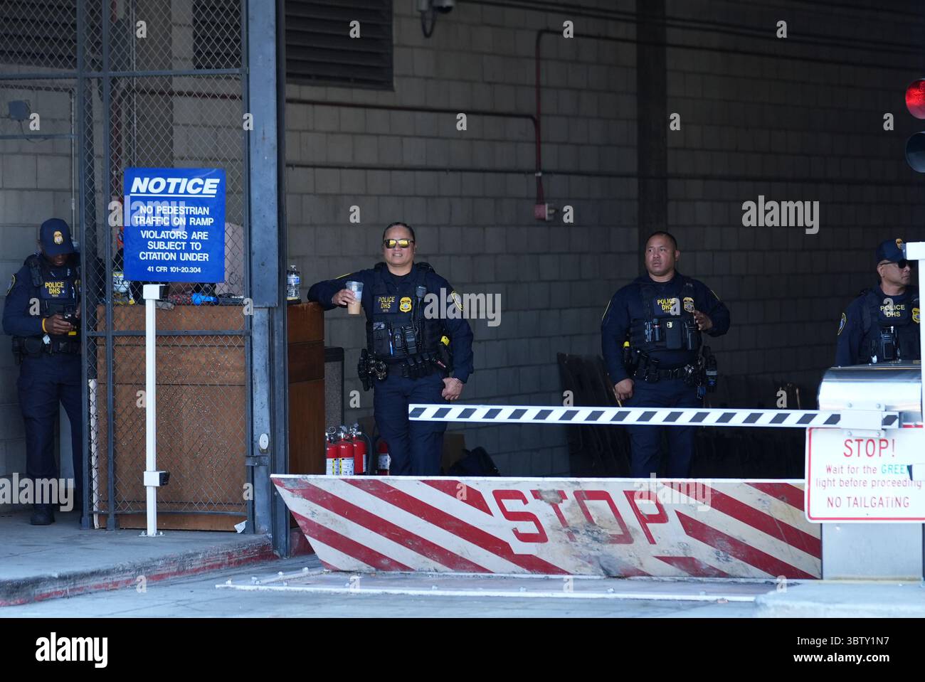 Department of Homeland Security (DHS) agents guard the entrance to the ...