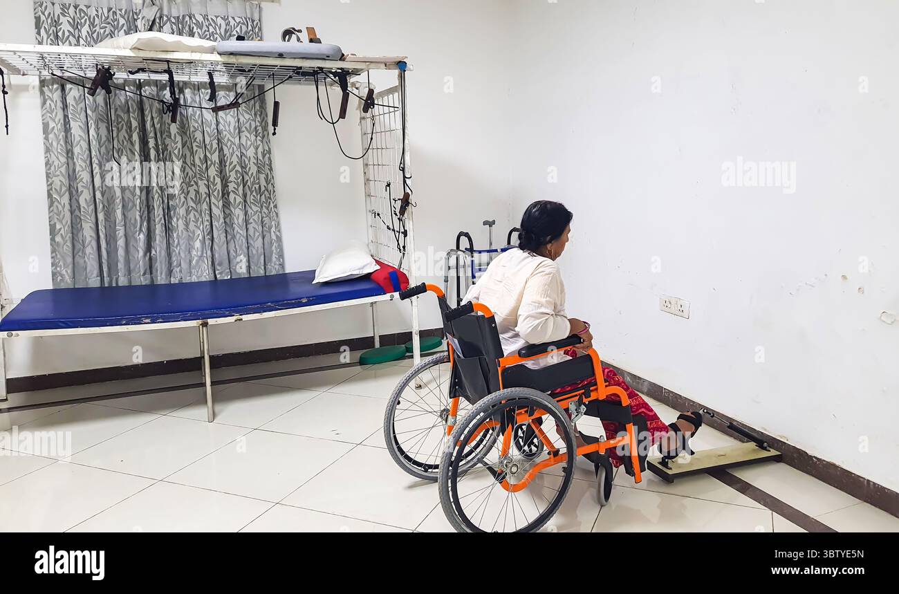 wheelchair patient performing paralyzed foot recovery exercise in ...