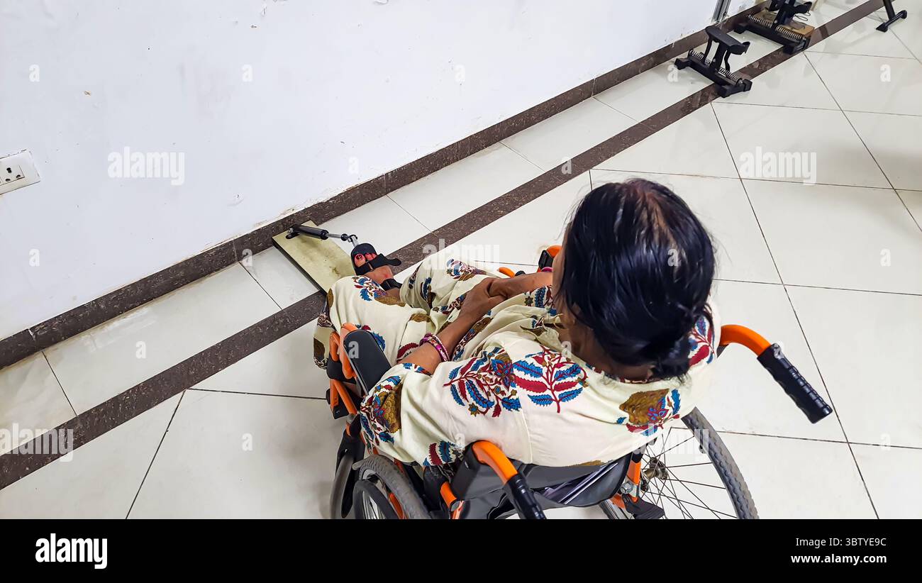 wheel chair patient performing therapy session for improving paralyzed ...
