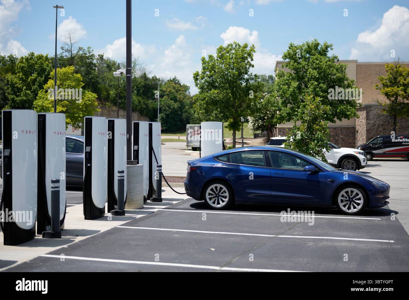 A Tesla electronic vehicle is parked a charging station Tuesday, July ...