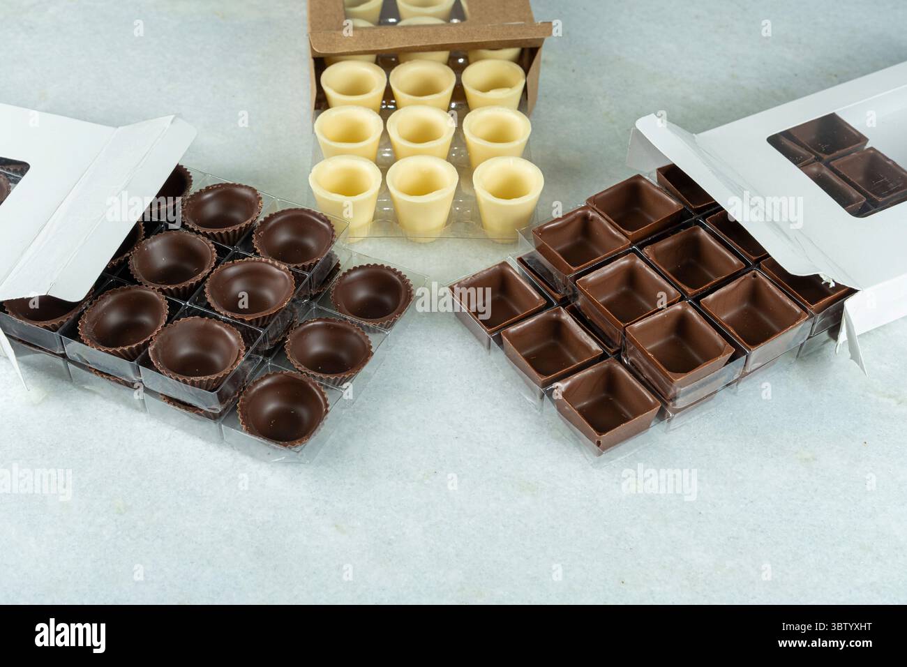Various types of chocolates in different shapes inside boxes Stock ...