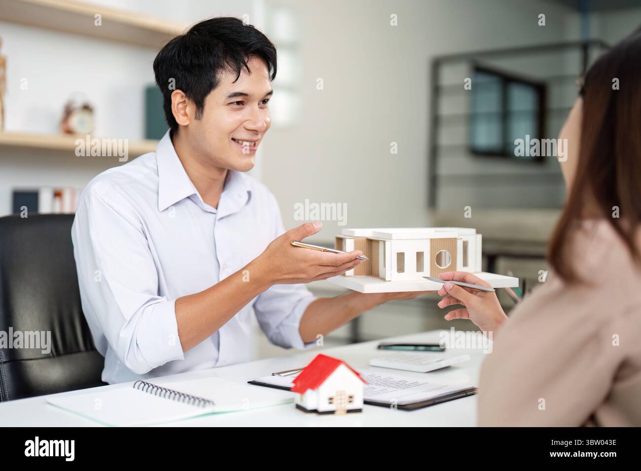 Real Estate Agent Presenting Model Home to Client Stock Photo - Alamy