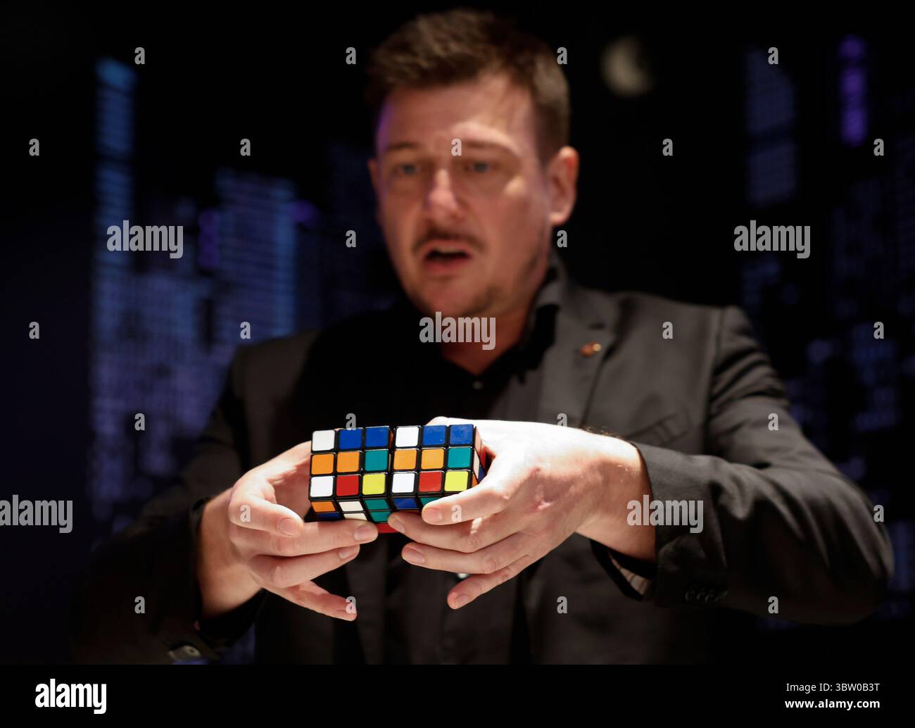 Jamie Allan performs a trick with a Rubik's Cube at the Jamie Allan's ...