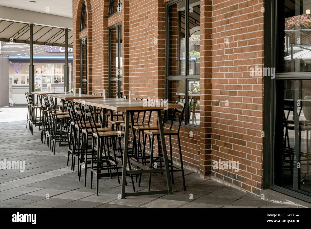 Jakarta, Indonesia, 15 July 2025. Outdoor patio seating area of a cafe ...