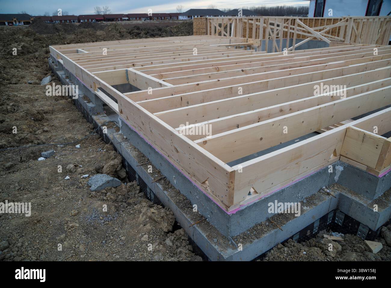 Wood floor joist on top of basement foundation wall Stock Photo - Alamy