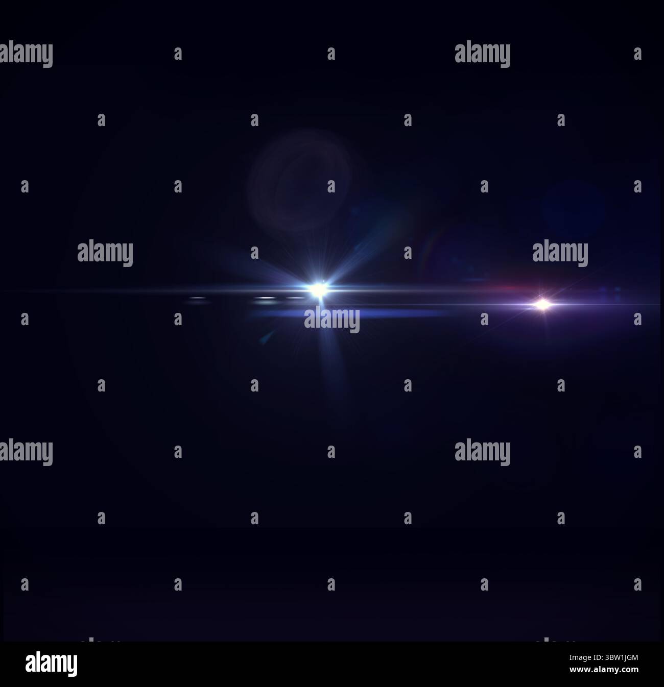 Glowing lens flare against black background Stock Photo - Alamy