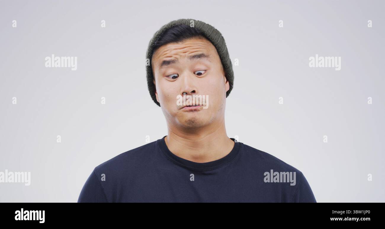 Comic, funny face and goofy with man on studio space for emotions ...