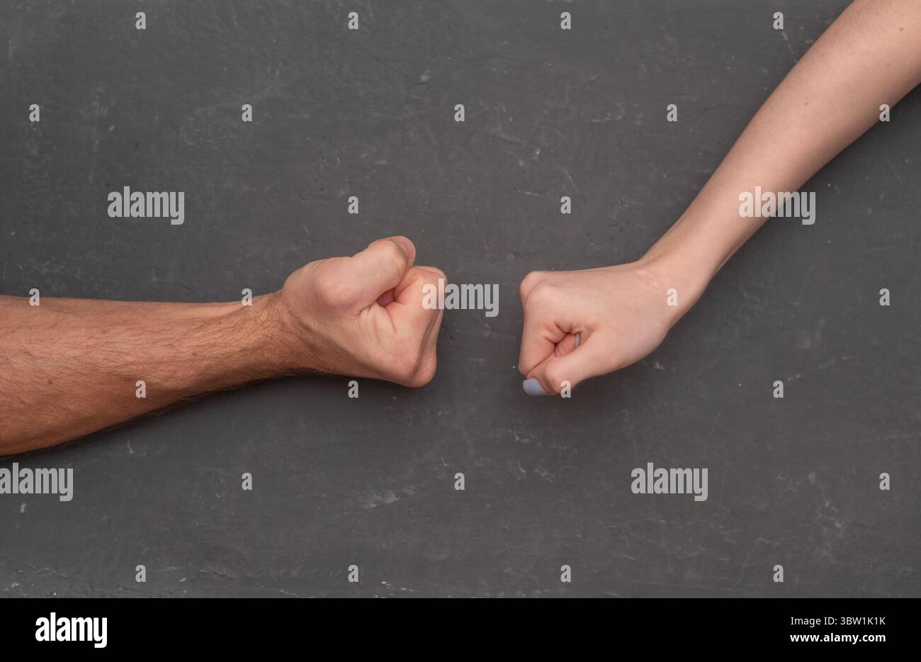 Frontal view of interlocked fists creating perfect symmetry. gray ...
