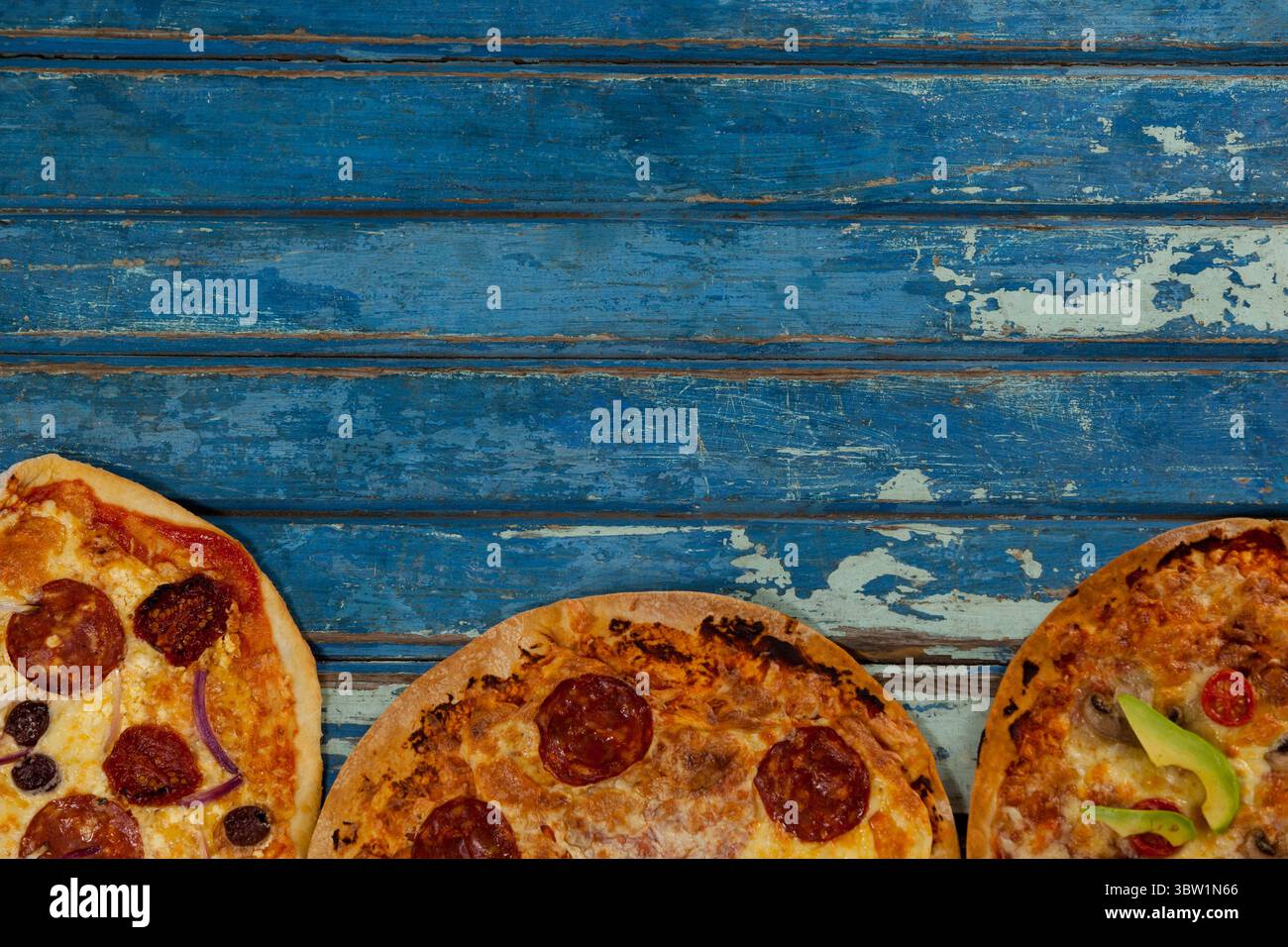 Fresh pizzas on blue hi-res stock photography and images - Alamy