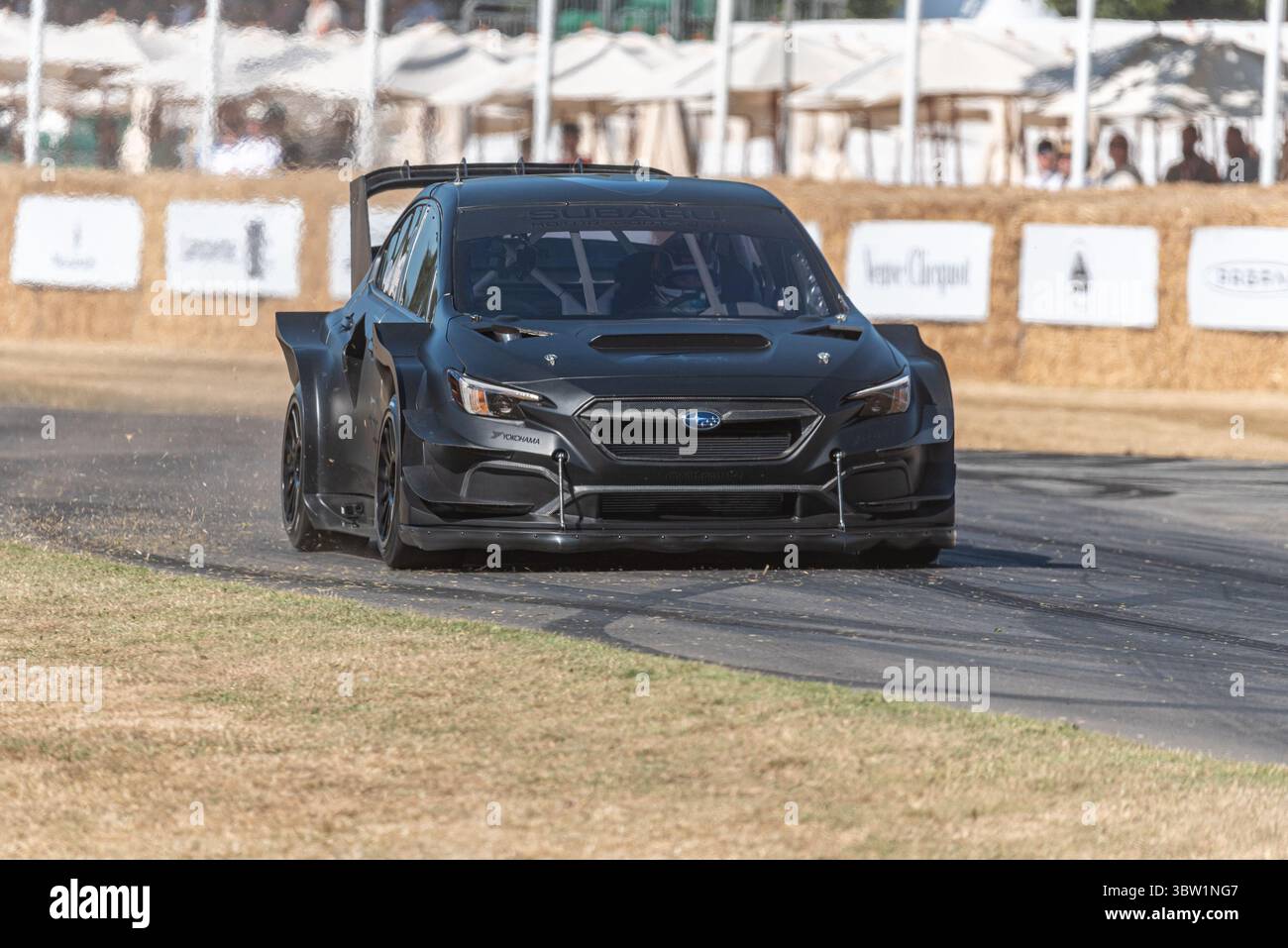 Subaru Project Midnight race car driving up the hillclimb track at the ...