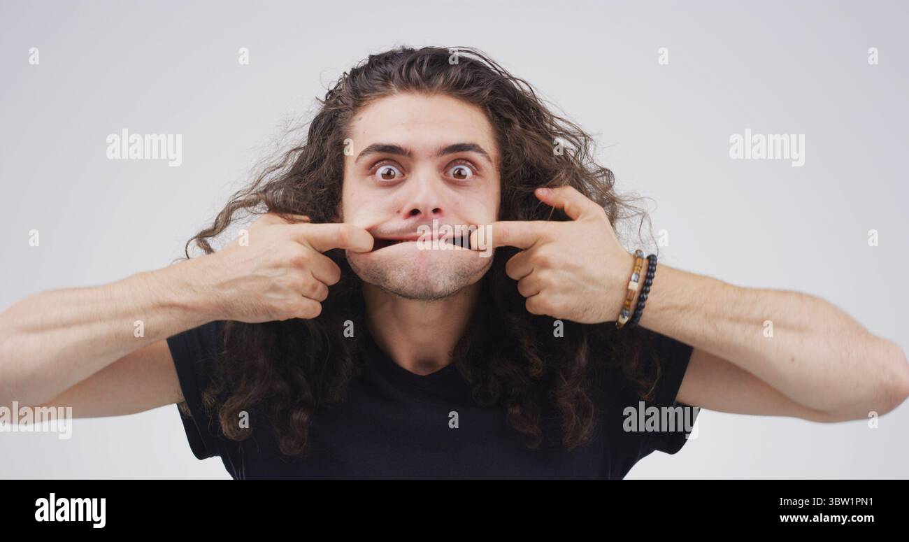 Funny face, stretching and portrait of man in studio for theater prep ...