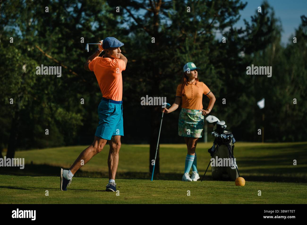Golfers enjoying a sunny day on the course while practicing their ...