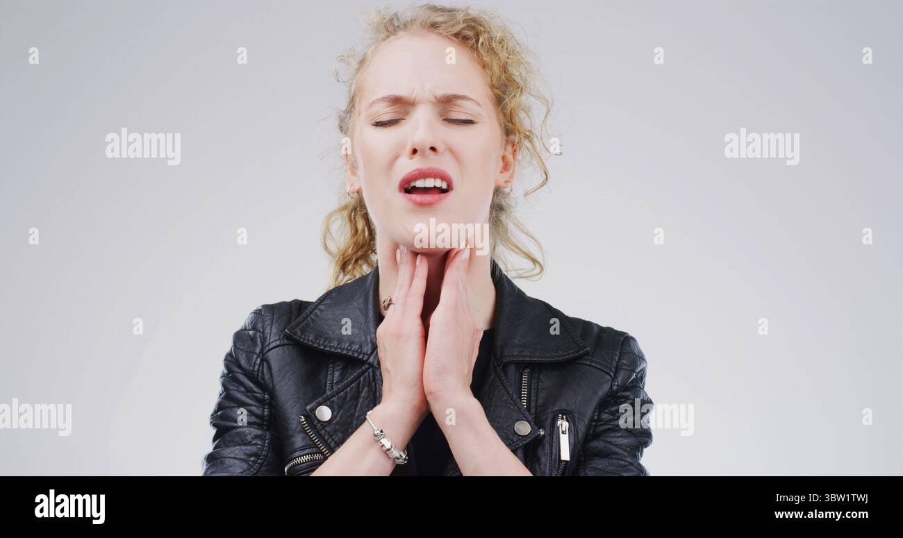 Glands, hurt and woman with pain on studio space for cold, sore throat ...
