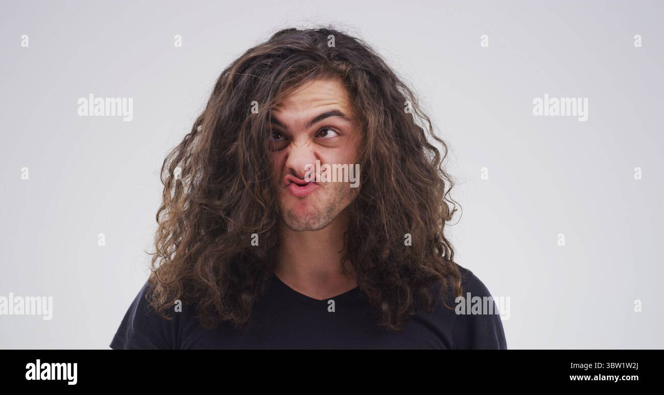 Silly, crazy and man in studio with funny face for playful, comedy and ...