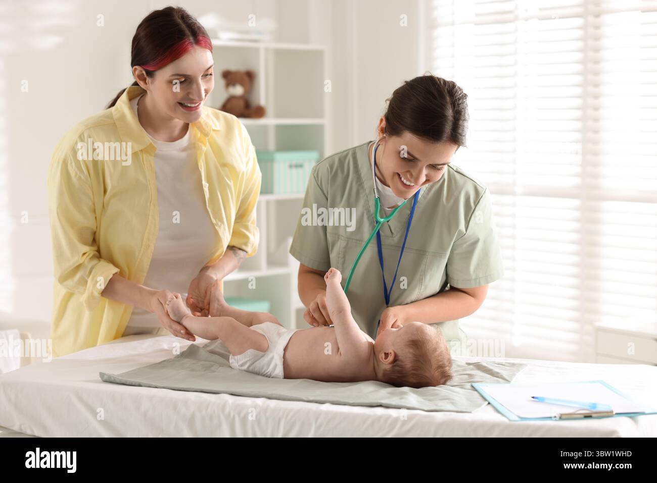 Mother and her cute little child having appointment with pediatrician ...