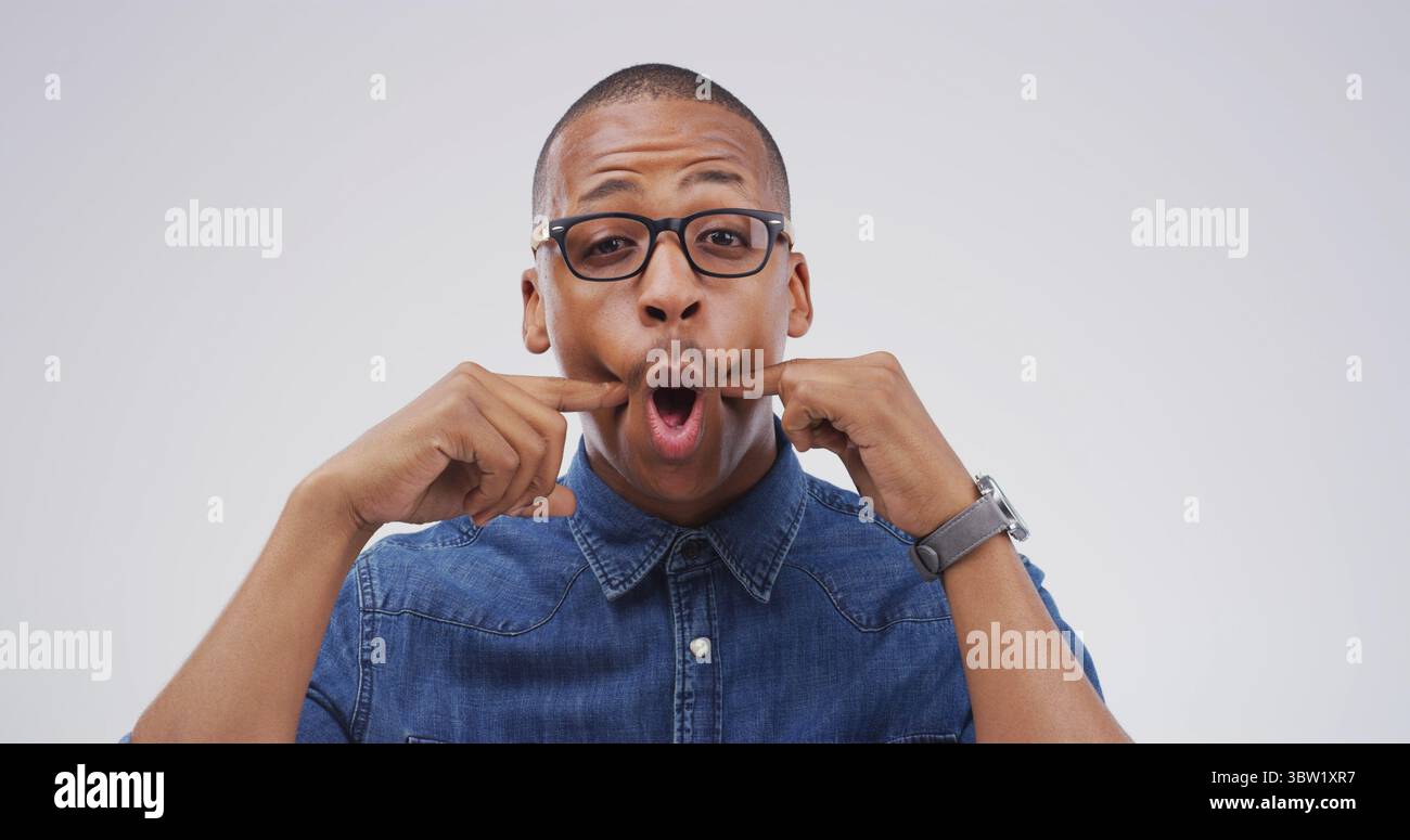 Portrait, funny face and black man in studio with goofy expression on ...