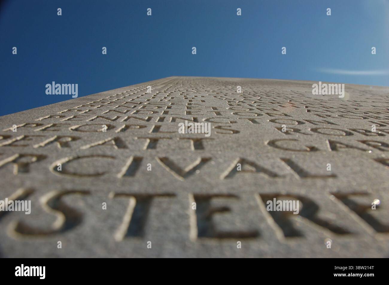Close-up upward view of engraved names on a granite memorial wall ...