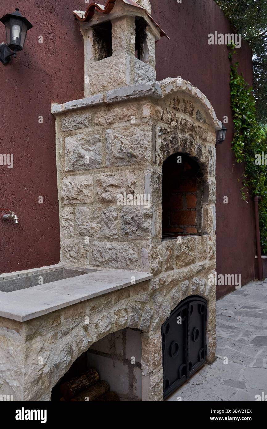 Rustic stone brick pizza oven featuring a classic chimney design ...