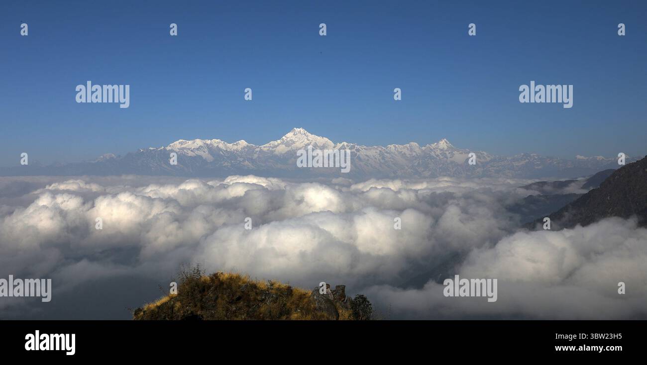 A breathtaking view of Mount Kanchenjunga rising above a sea of clouds ...