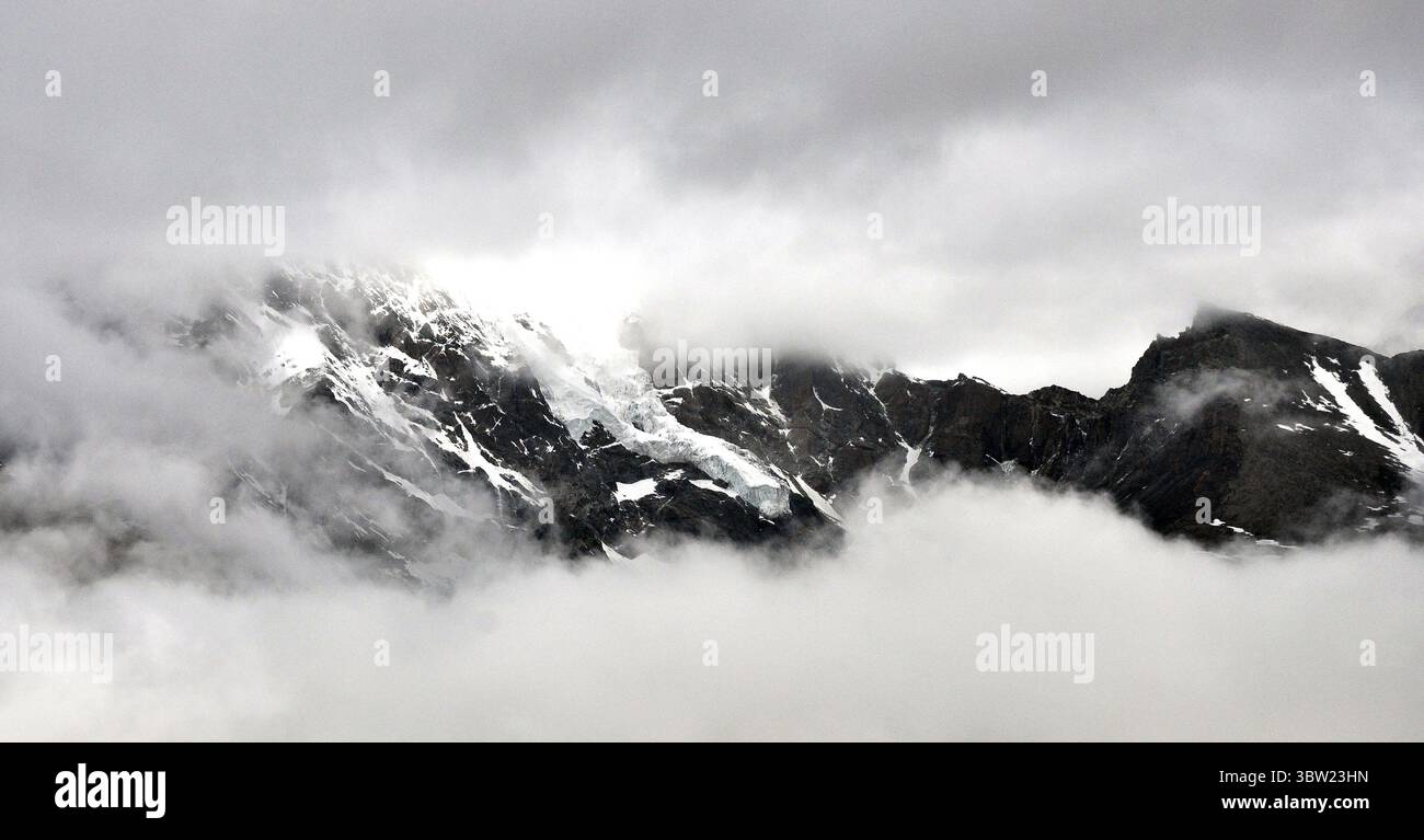 A hauntingly beautiful view of the Himalayan mountains partially hidden ...