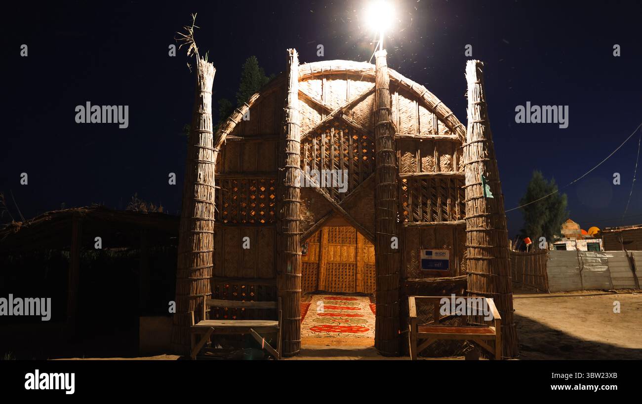 In the Mesopotamian Marshes, a traditional reed house is illuminated at ...