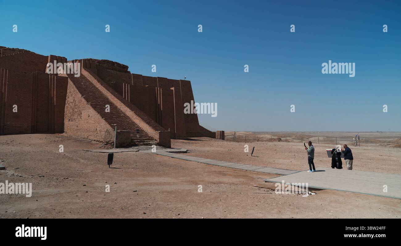 Visitors stand near the Ziggurat of Ur, an ancient Mesopotamian ...