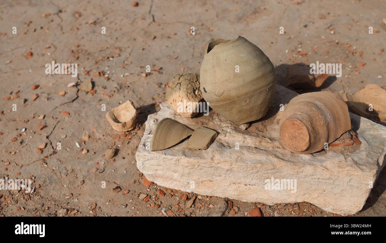 Ancient pottery pieces and artifacts are scattered on the ground in ...