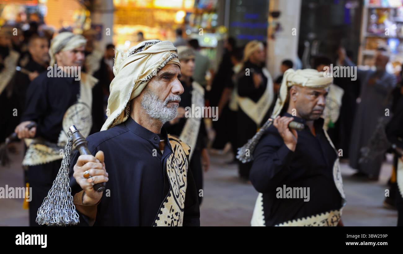 Men in traditional attire participate in a cultural celebration in An ...