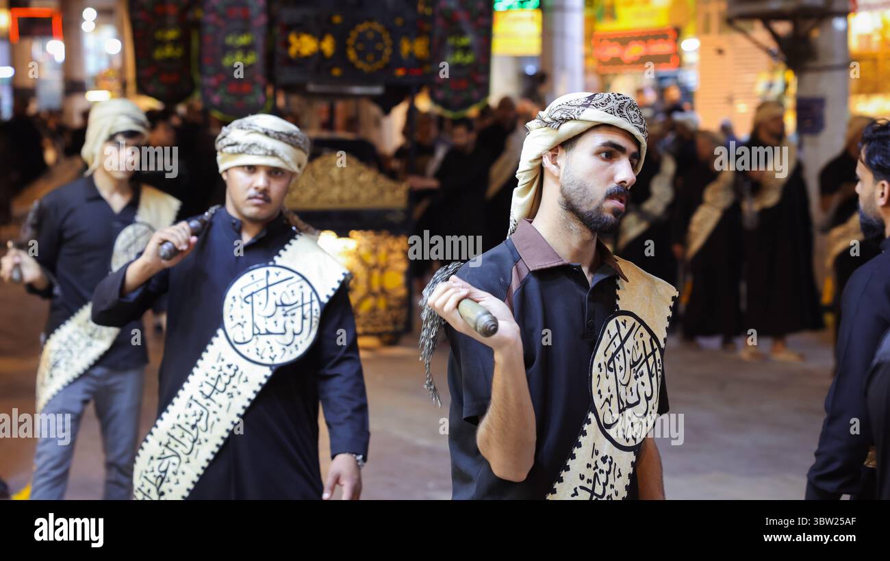 Men participate in a traditional procession in An Najaf, Iraq, wearing ...