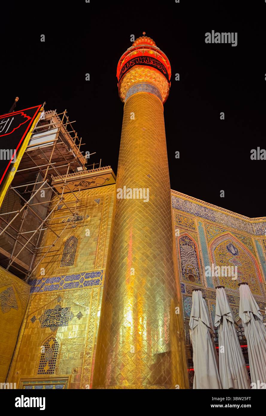 Illuminated golden minaret of Imam Ali shrine in Najaf stands tall at ...
