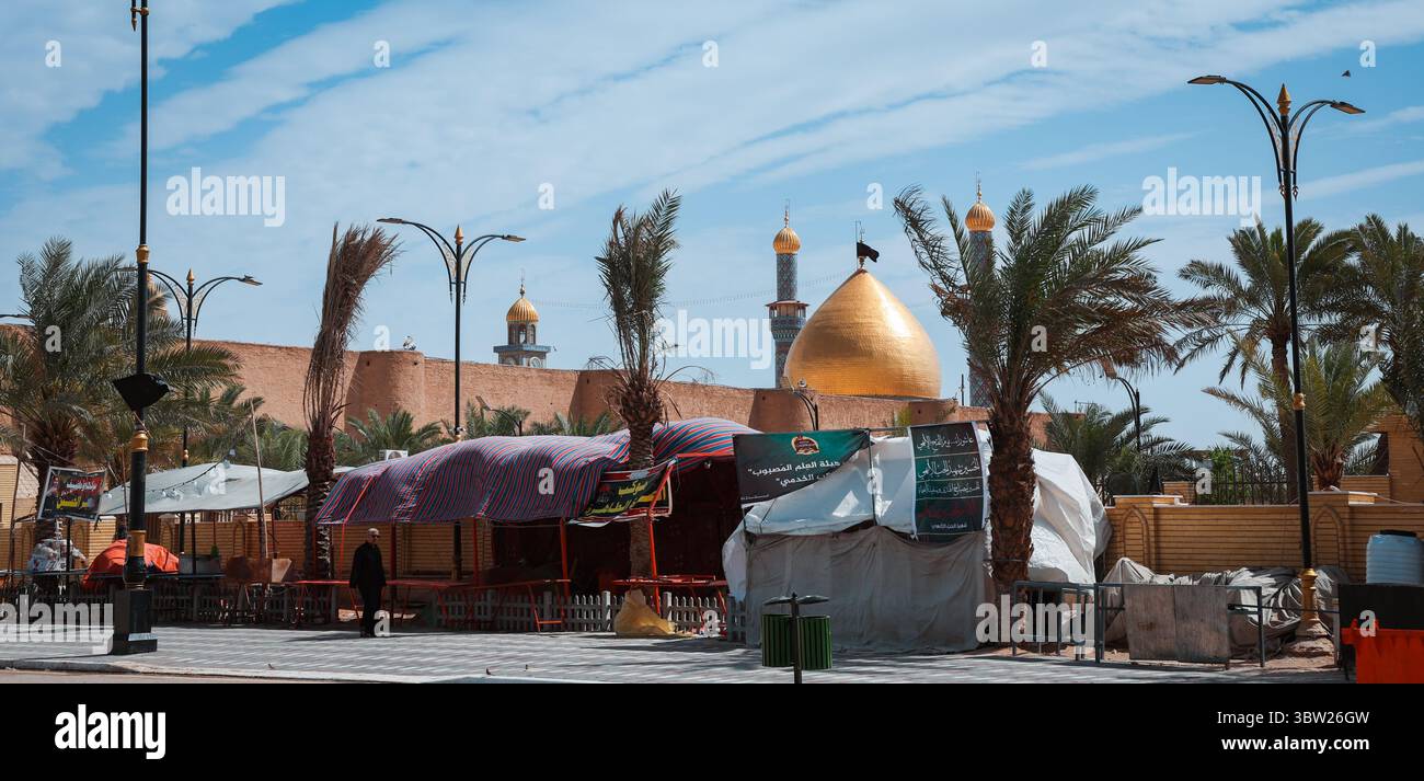 Palm trees sway gently as people gather in Kufa, Iraq, showcasing ...