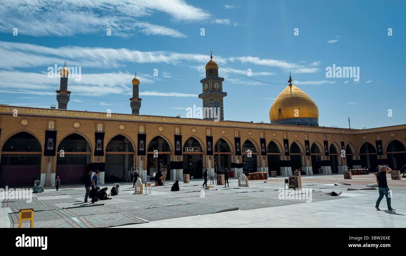 Visitors explore a historical religious site in Kufa, Iraq, featuring ...