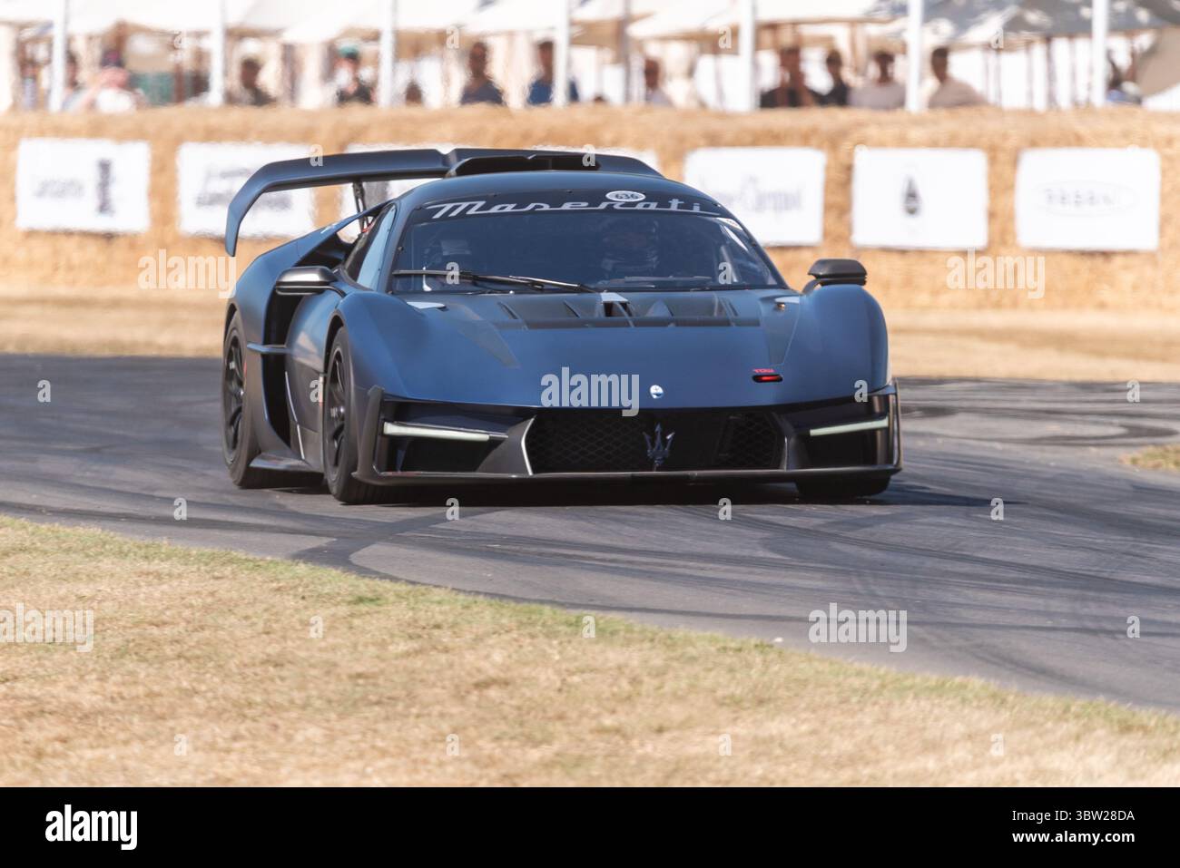 Maserati MCXtrema track car driving up hillclimb track at Goodwood ...