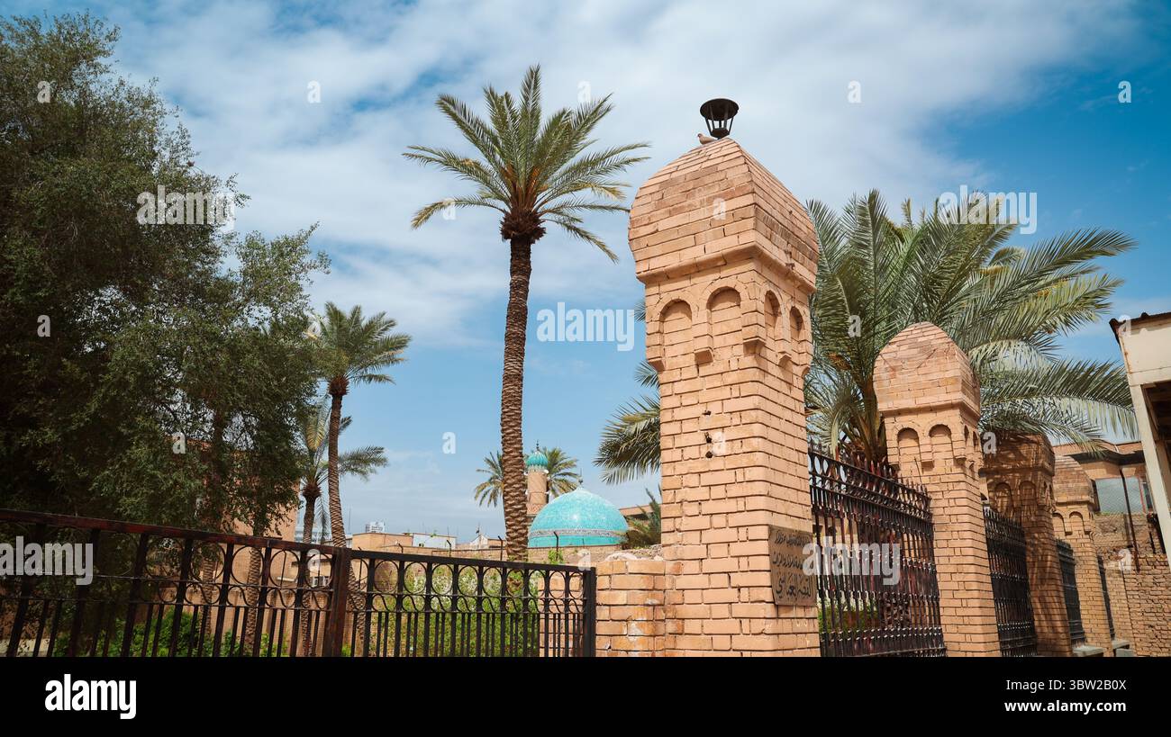 Historic buildings with intricate designs stand next to lush palm trees ...