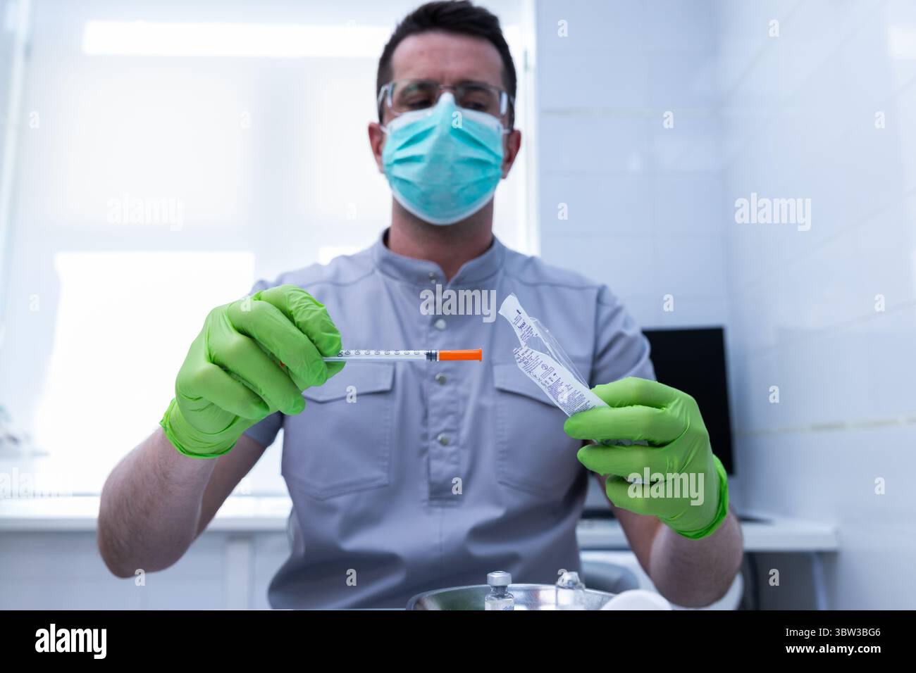 Health Professional Preparing Medical Syringe with Vial in a Sterile ...