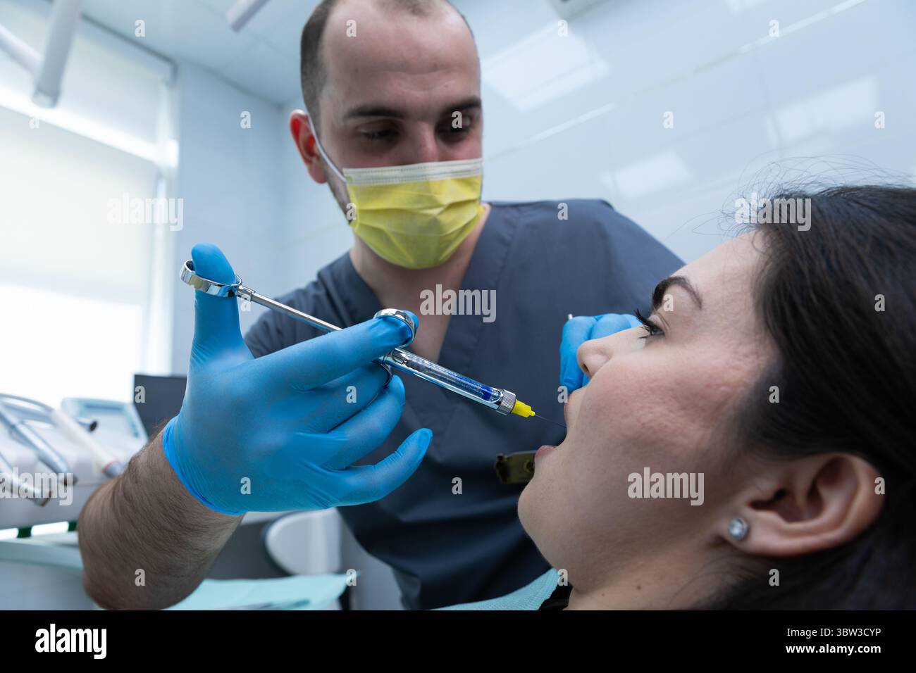 Professional Dentist Administering Local Anesthesia to Patient During ...