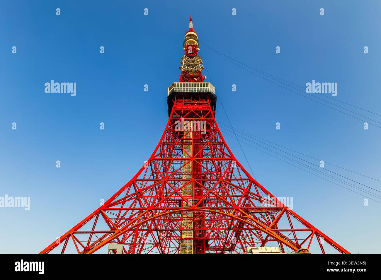 View of the vibrant red Tokyo Tower stretching high against a clear ...