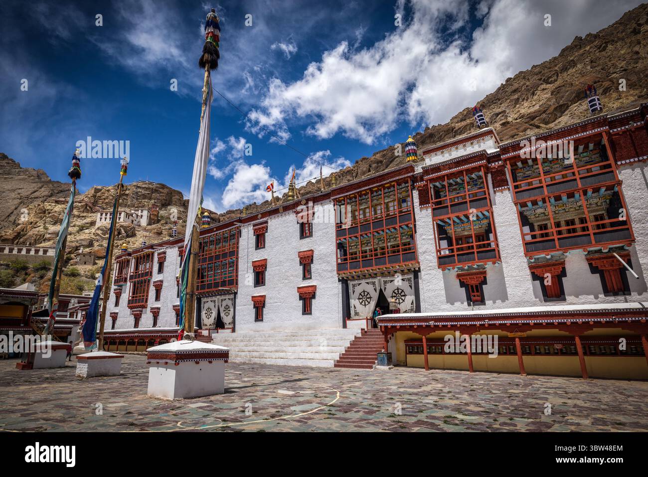 View of a monastery with white walls and red trim standing proudly ...