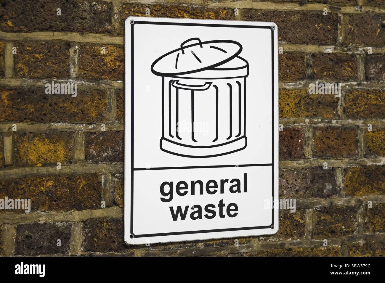 General waste sign fixed to brick wall, encouraging proper disposal of ...