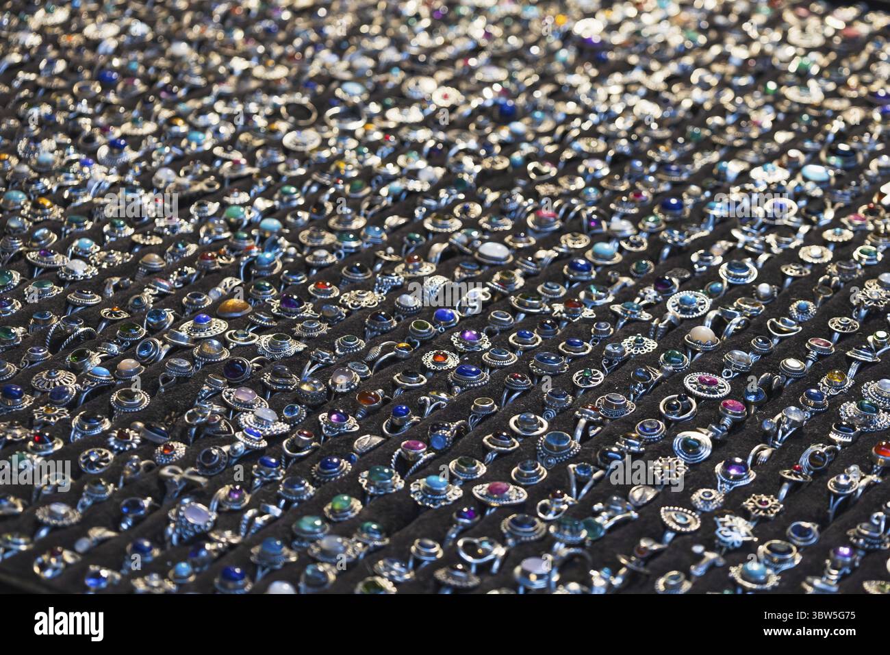 Market stall covered with hundreds of metallic rings in organized rows ...
