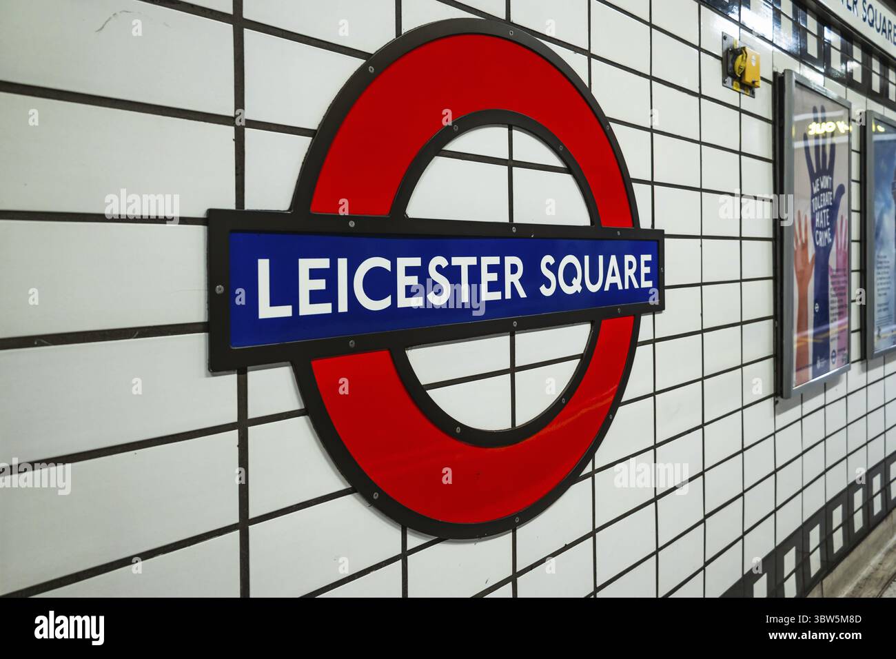 A detailed shot of the Leicester Square station roundel sign ...