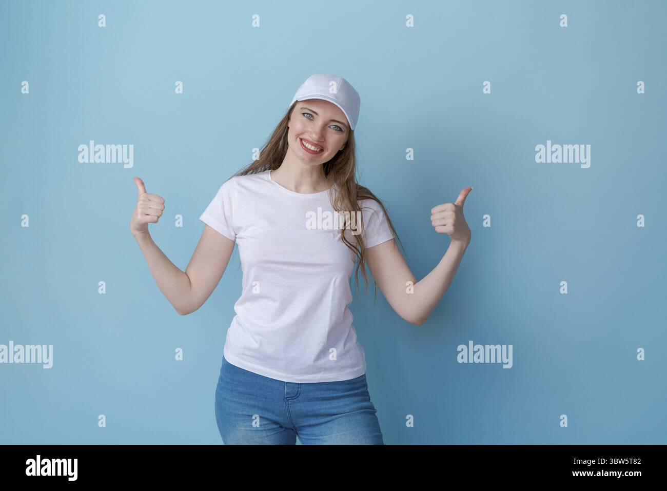 Hey look. Smiling beautiful female model pointing her fingers to an ...