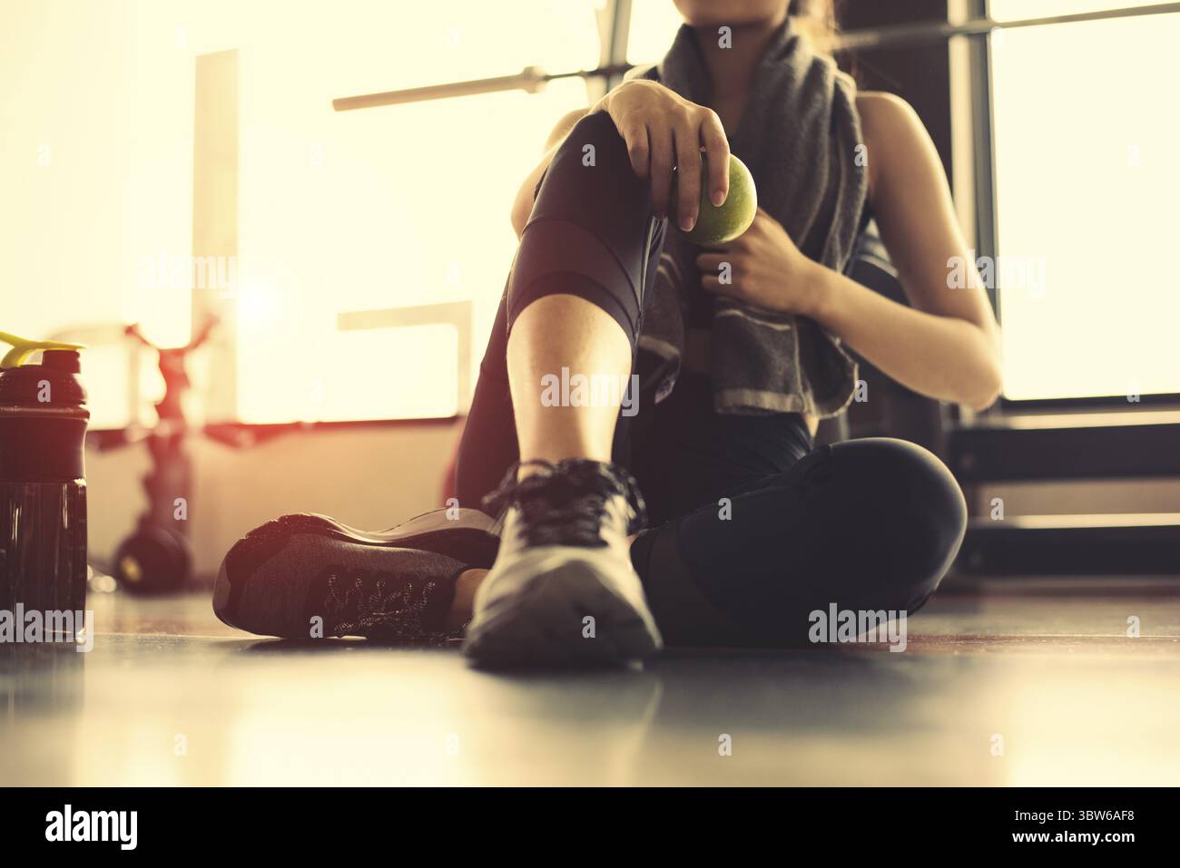 Sport woman exercise workout in fitness sport gym holding green apple ...