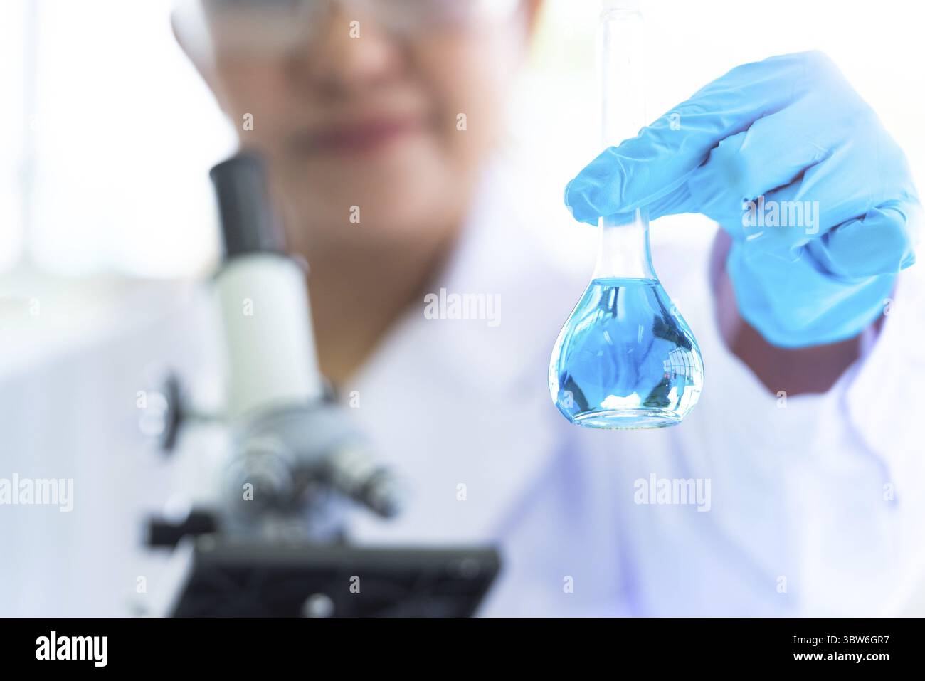 Female scientist hold and showing laboratory test tubes and solution ...